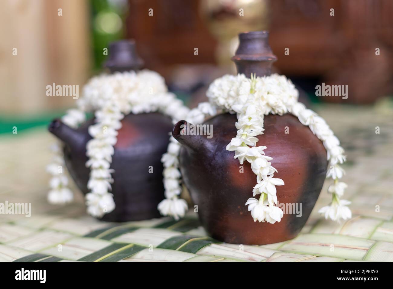 Jasmine flowers decorated on water clay jug or known as kendi as a ...