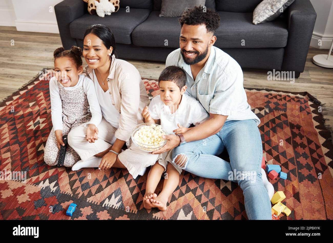 Happy, bonding family quality time at home with parents watching a ...