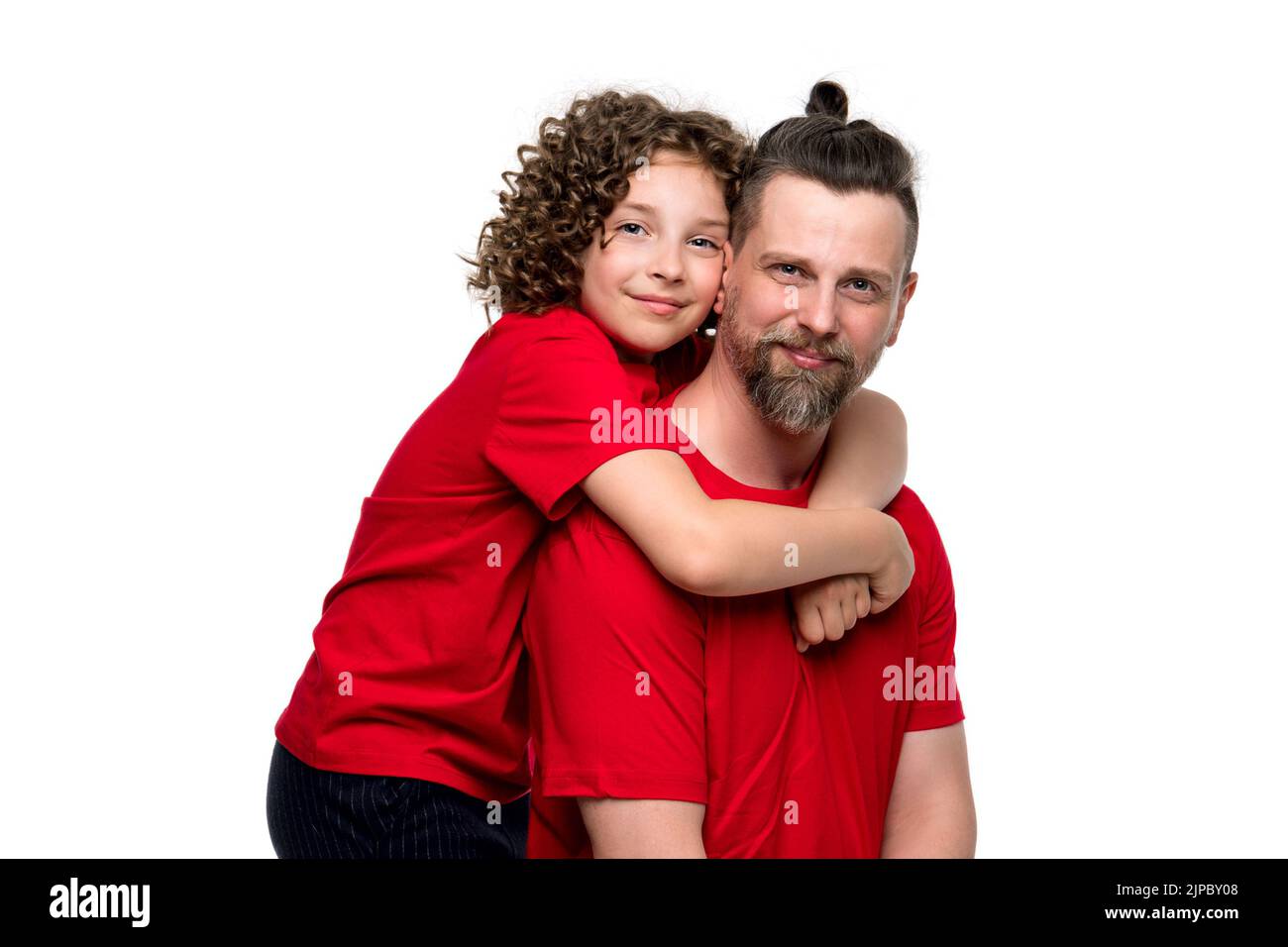 Handsome single father holding piggyback adorable 10-12s daughter ...