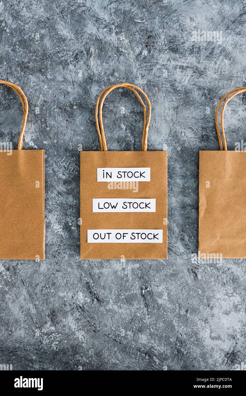 In stock, low stock and out of stock texts on top of shopping bags ...