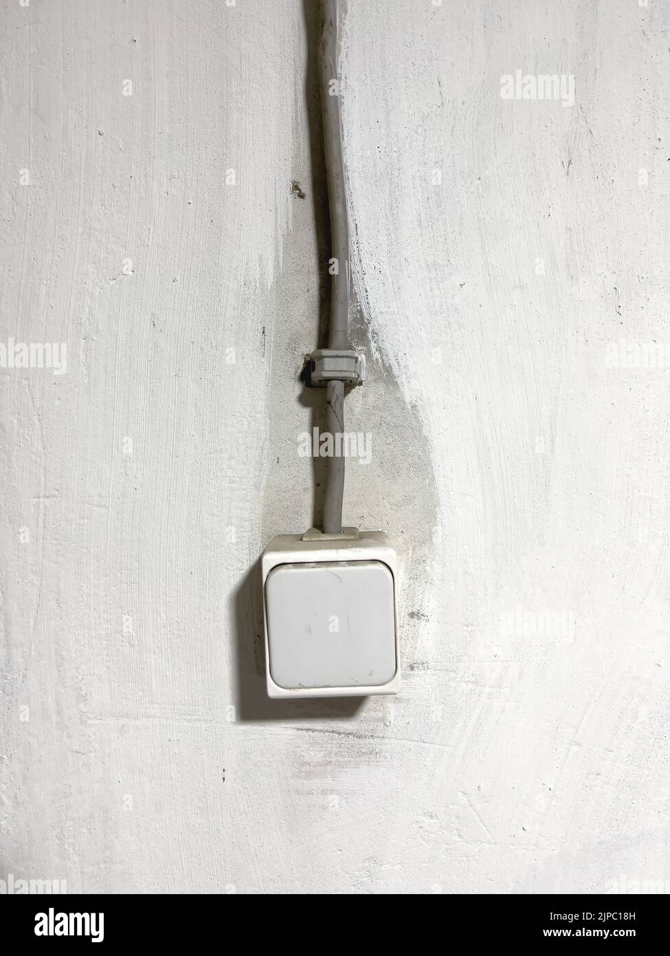 The vertical close-up view of an old light switch on the wall Stock ...