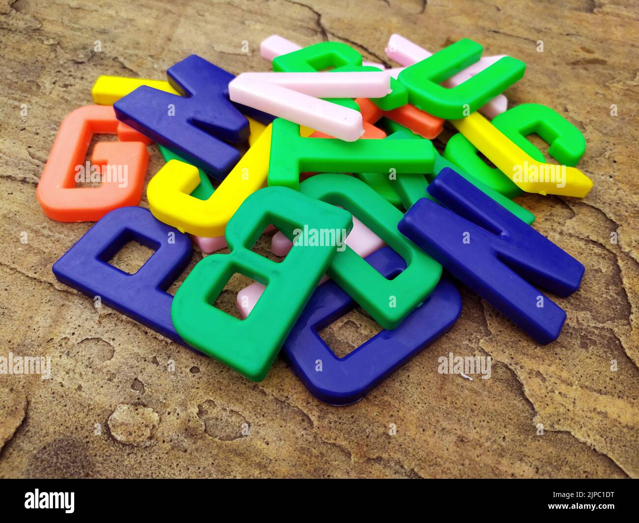 Multi color alphabet letter isolated on stone background Stock Photo ...
