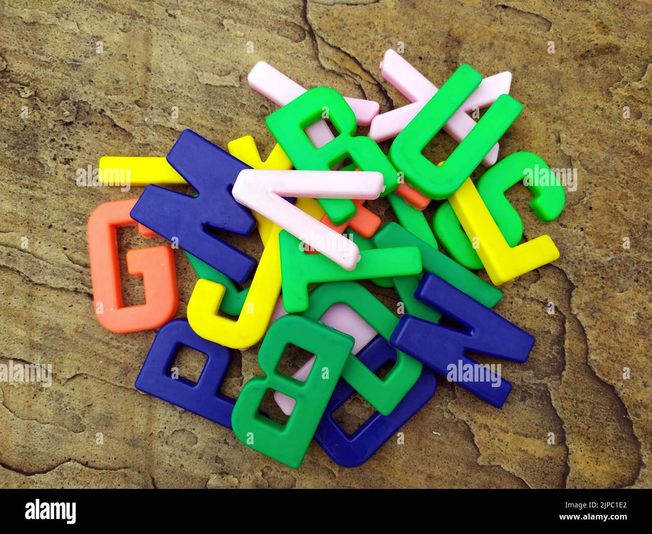 Multi color alphabet letter isolated on stone background Stock Photo ...