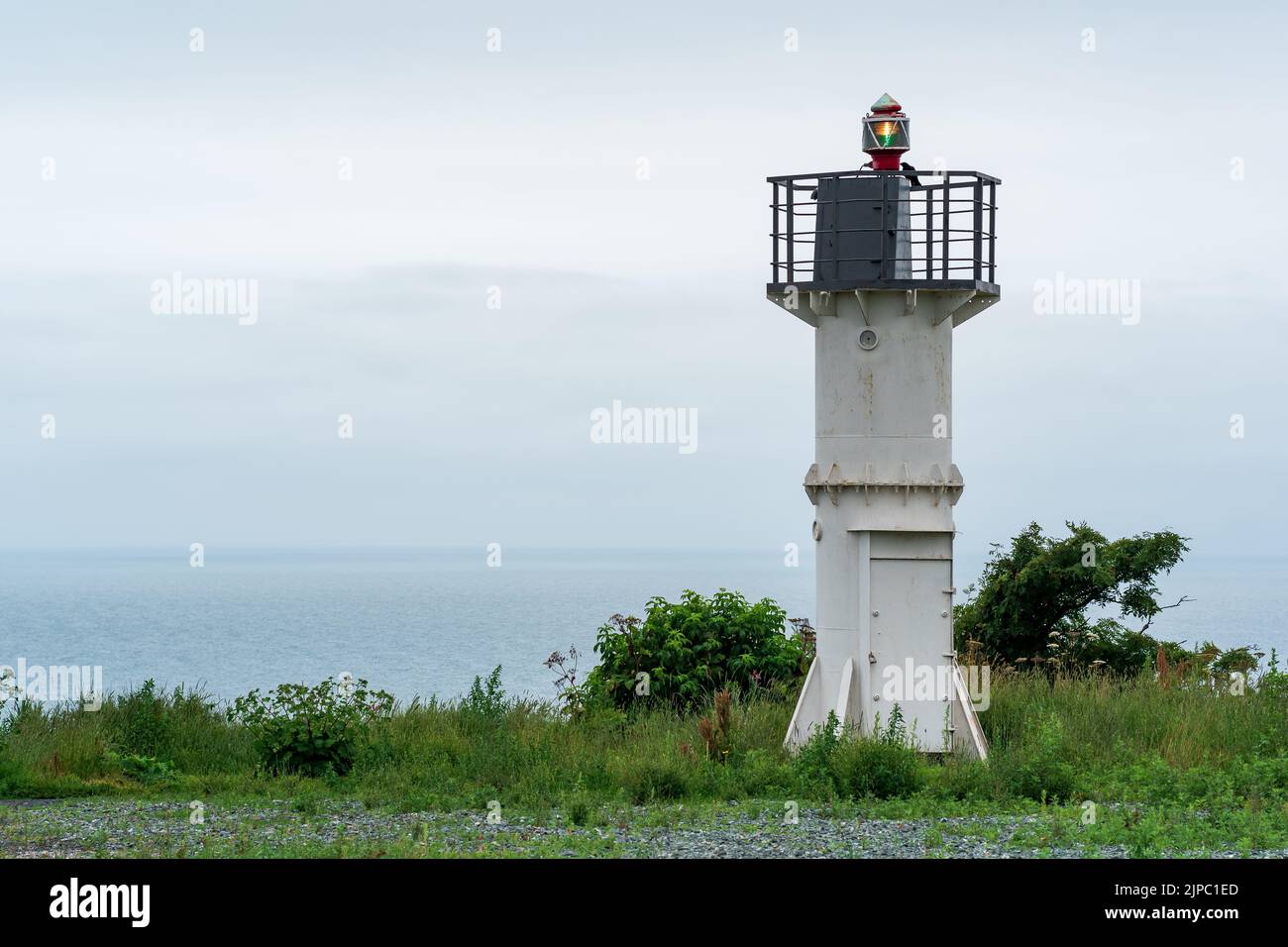 automatic lighthouse with sector light on a high cape above the sea ...
