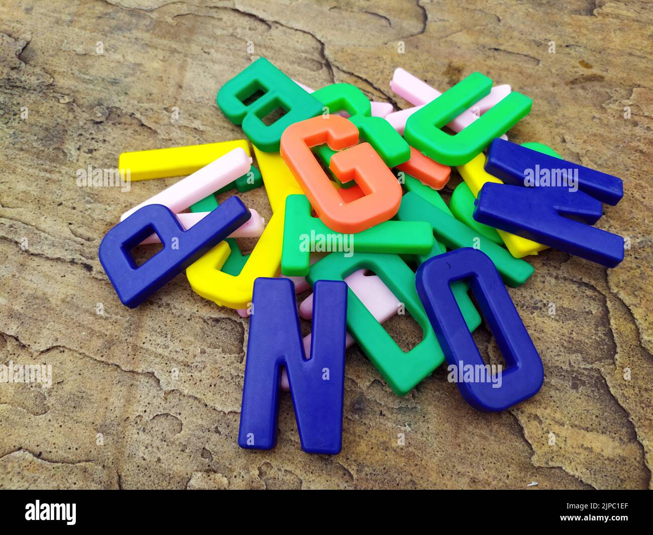 Multi color alphabet letter isolated on stone background Stock Photo ...