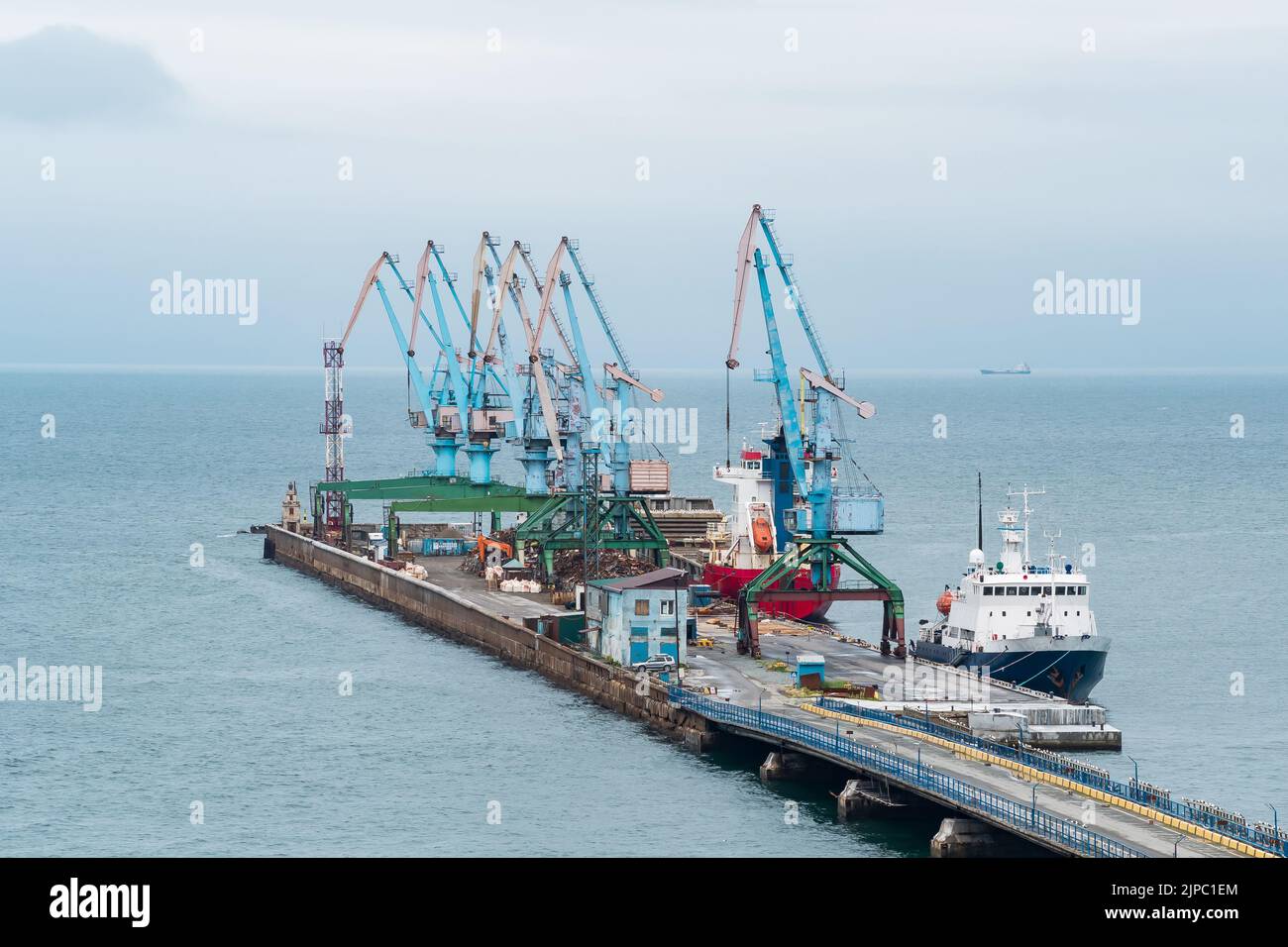 cargo berth with port cranes and moored ships against the backdrop of ...