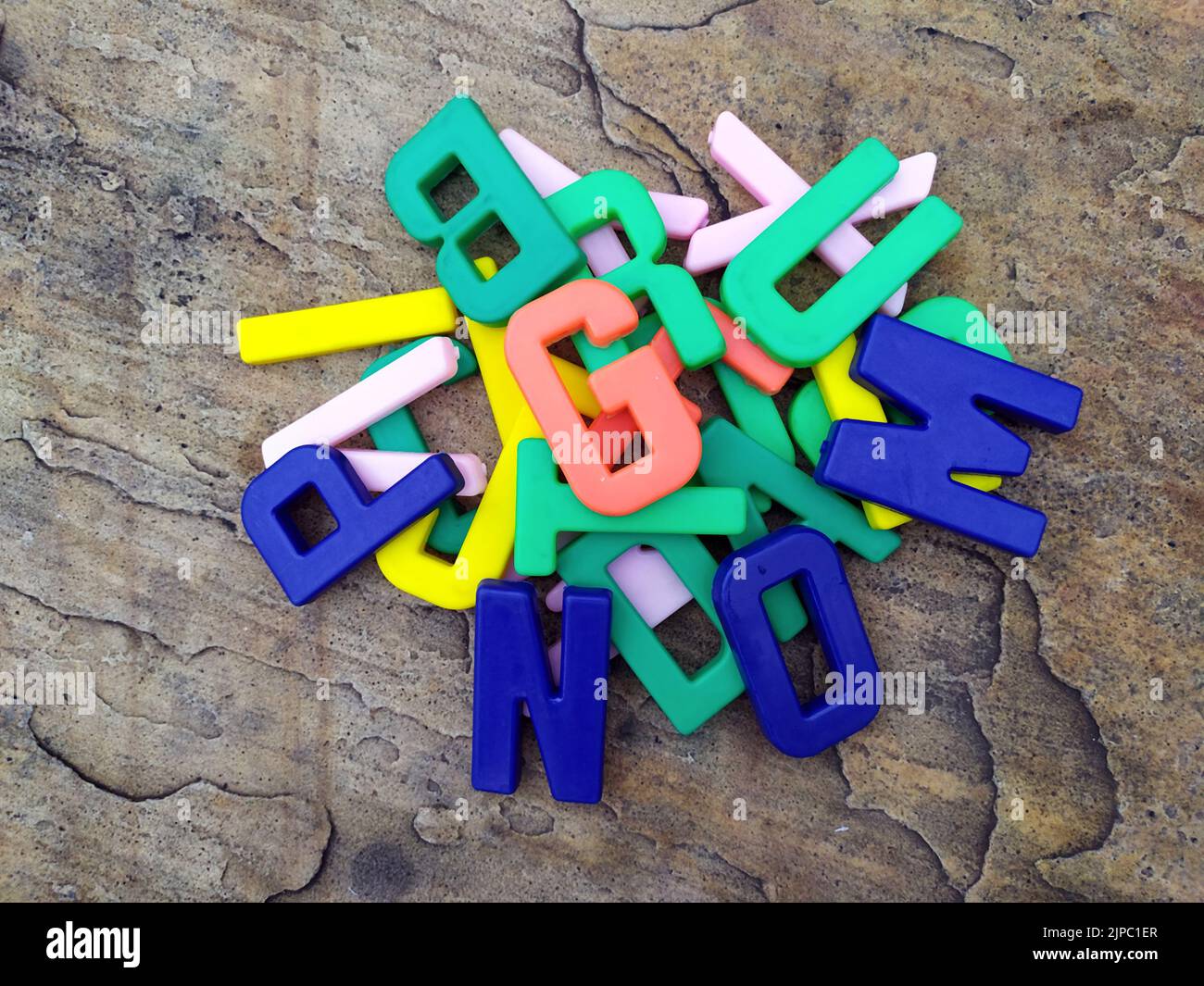 Multi color alphabet letter isolated on stone background Stock Photo ...