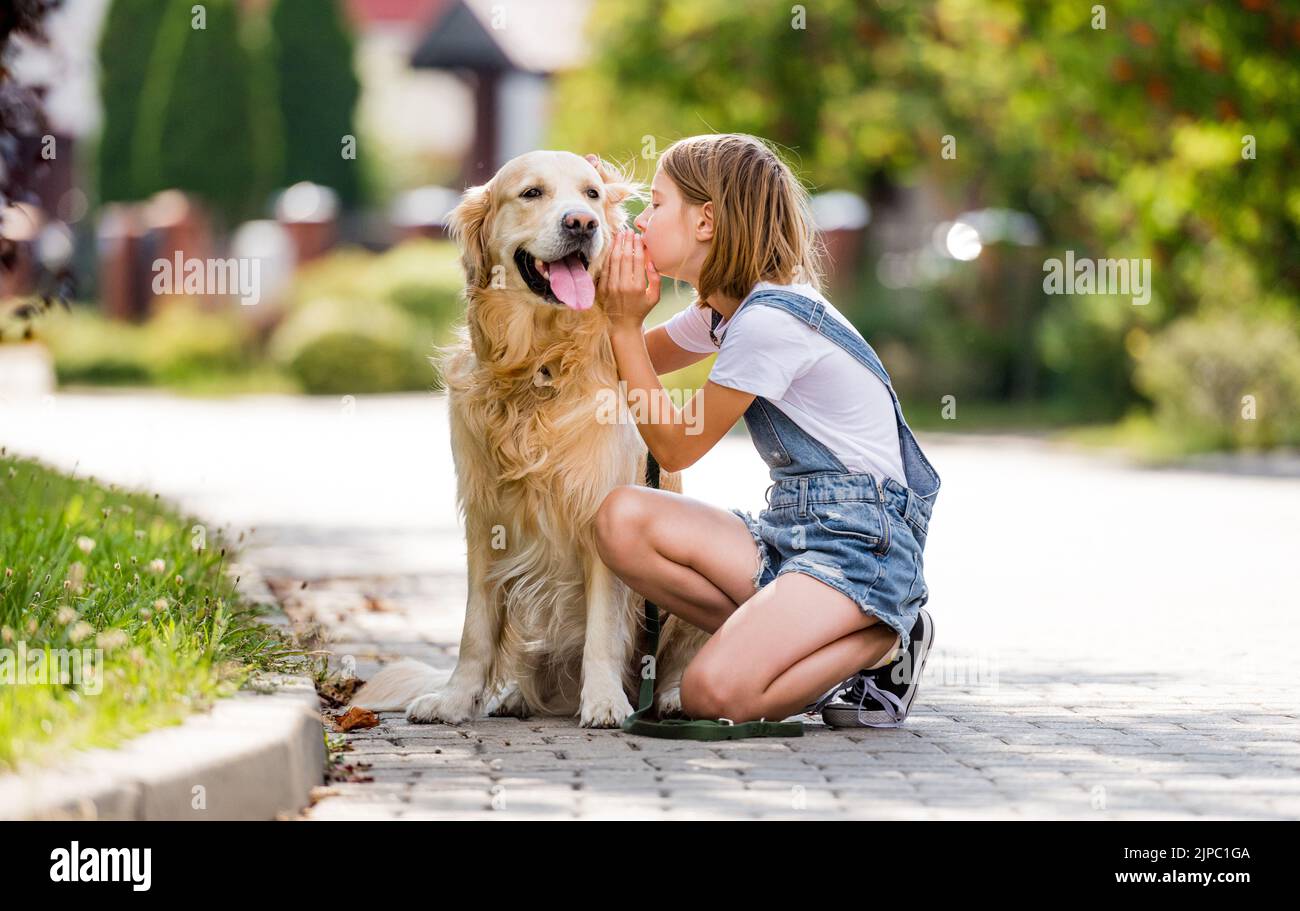 Girl with golden retriever dog Stock Photo - Alamy