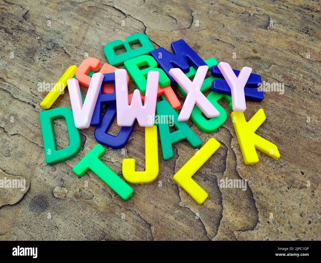 Multi color alphabet letter isolated on stone background Stock Photo ...