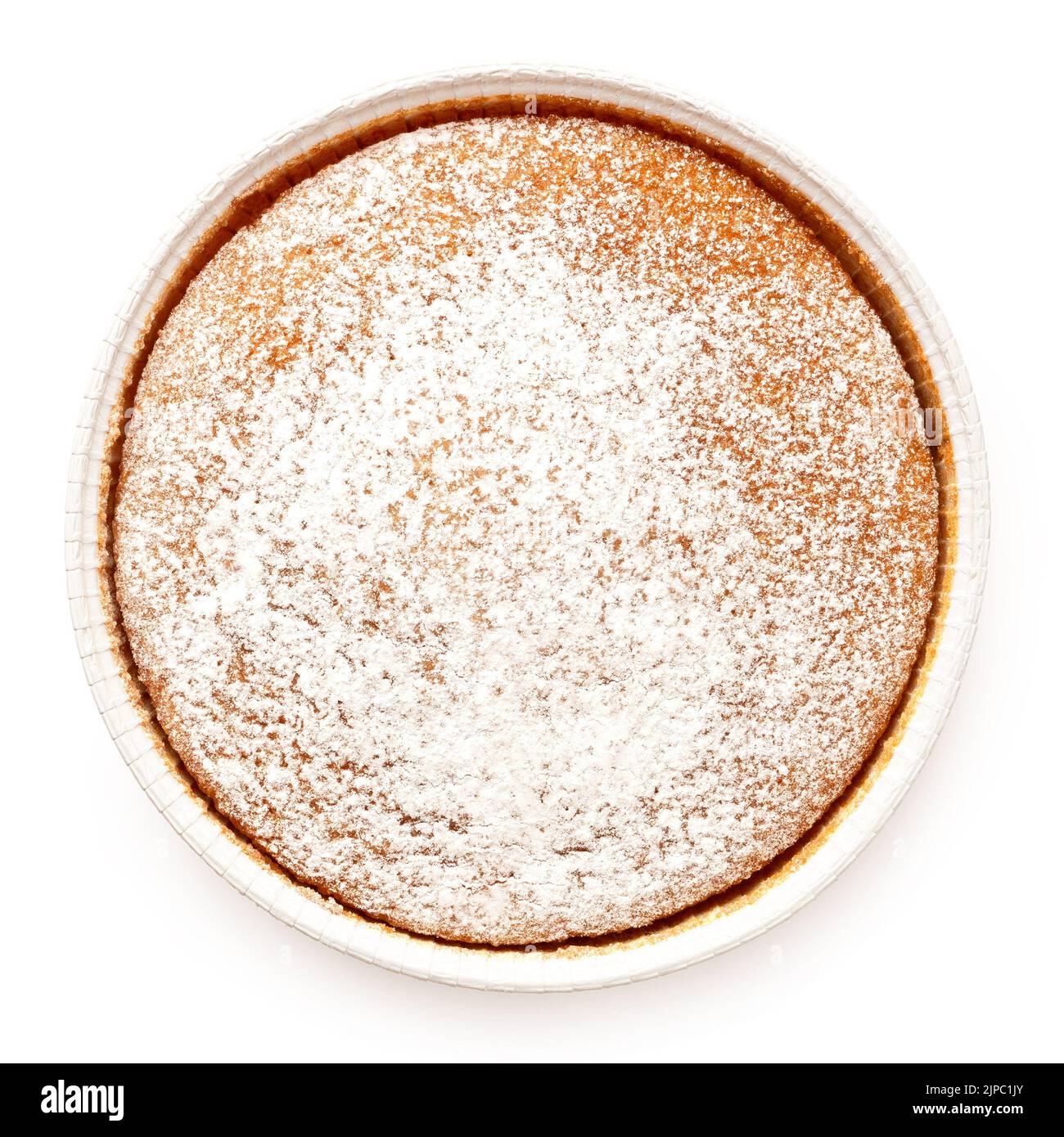 Whole lemon sponge cake with icing sugar topping in a paper tray ...