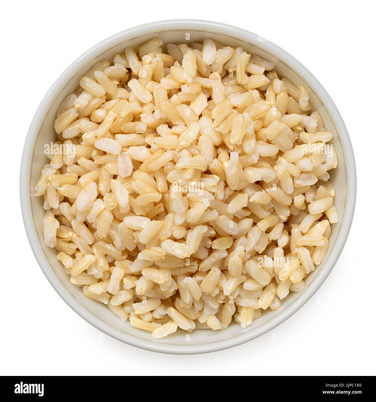 Brown cooked rice in a white ceramic bowl isolated on white. Top view ...