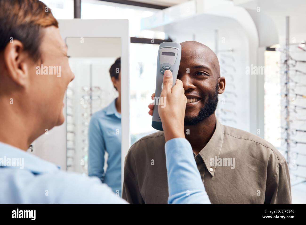 Eye exam, eyewear and an optometrist checking happy young male eyes ...