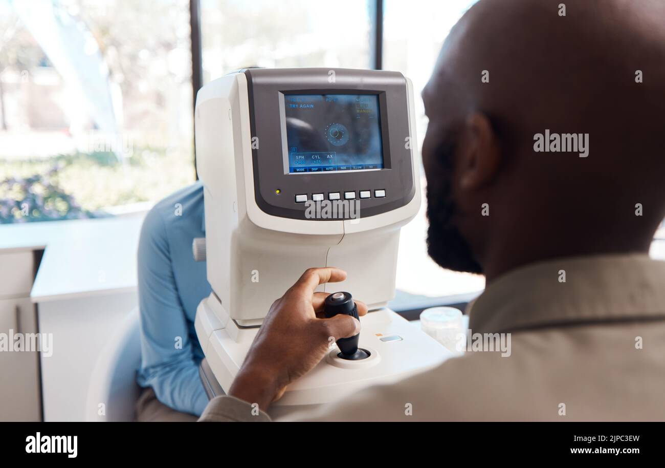 Eye exam by a doctor looking and checking the vision of a patient at a ...