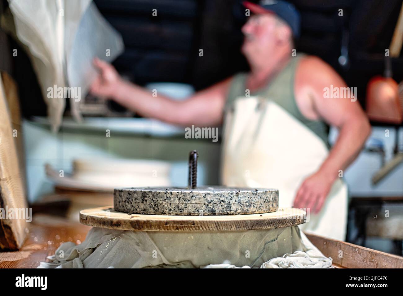 Local cheese production. Pressure to create typical cheese form of the ...