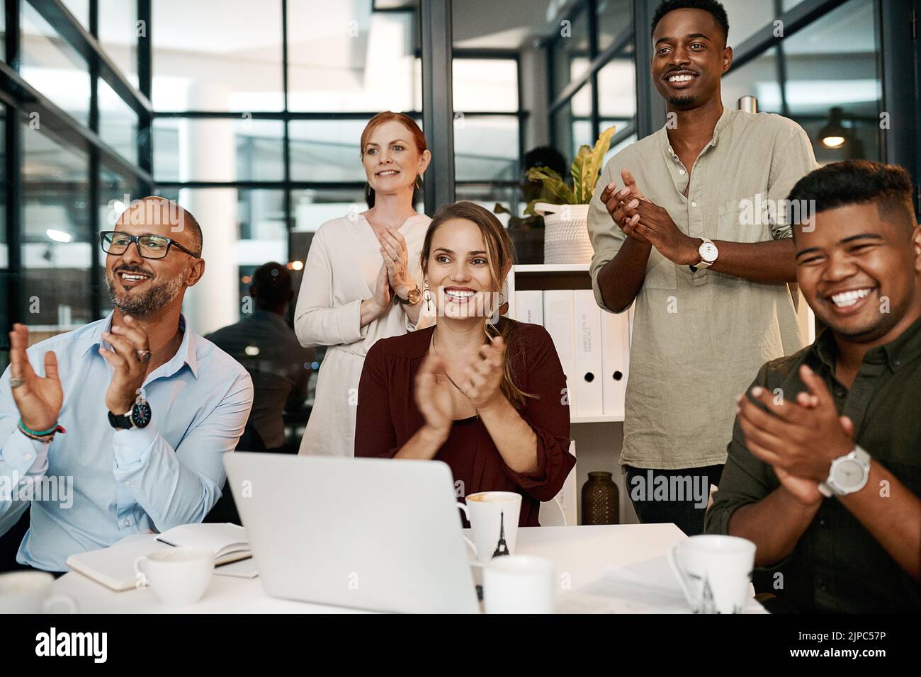 Clapping and cheering business people happy at a design conference ...