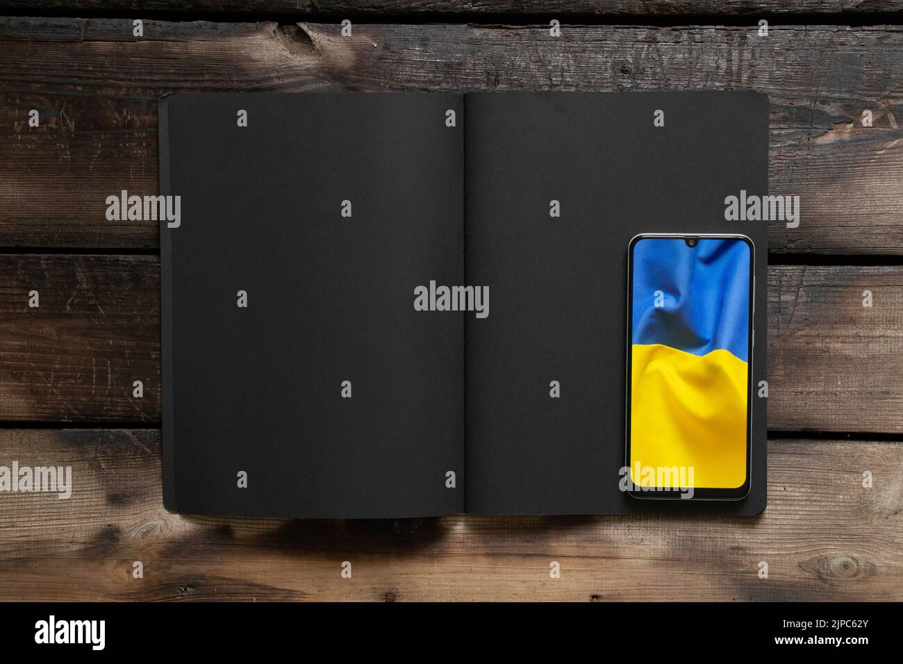 The national flag of Ukraine as a background on the phone and next to ...