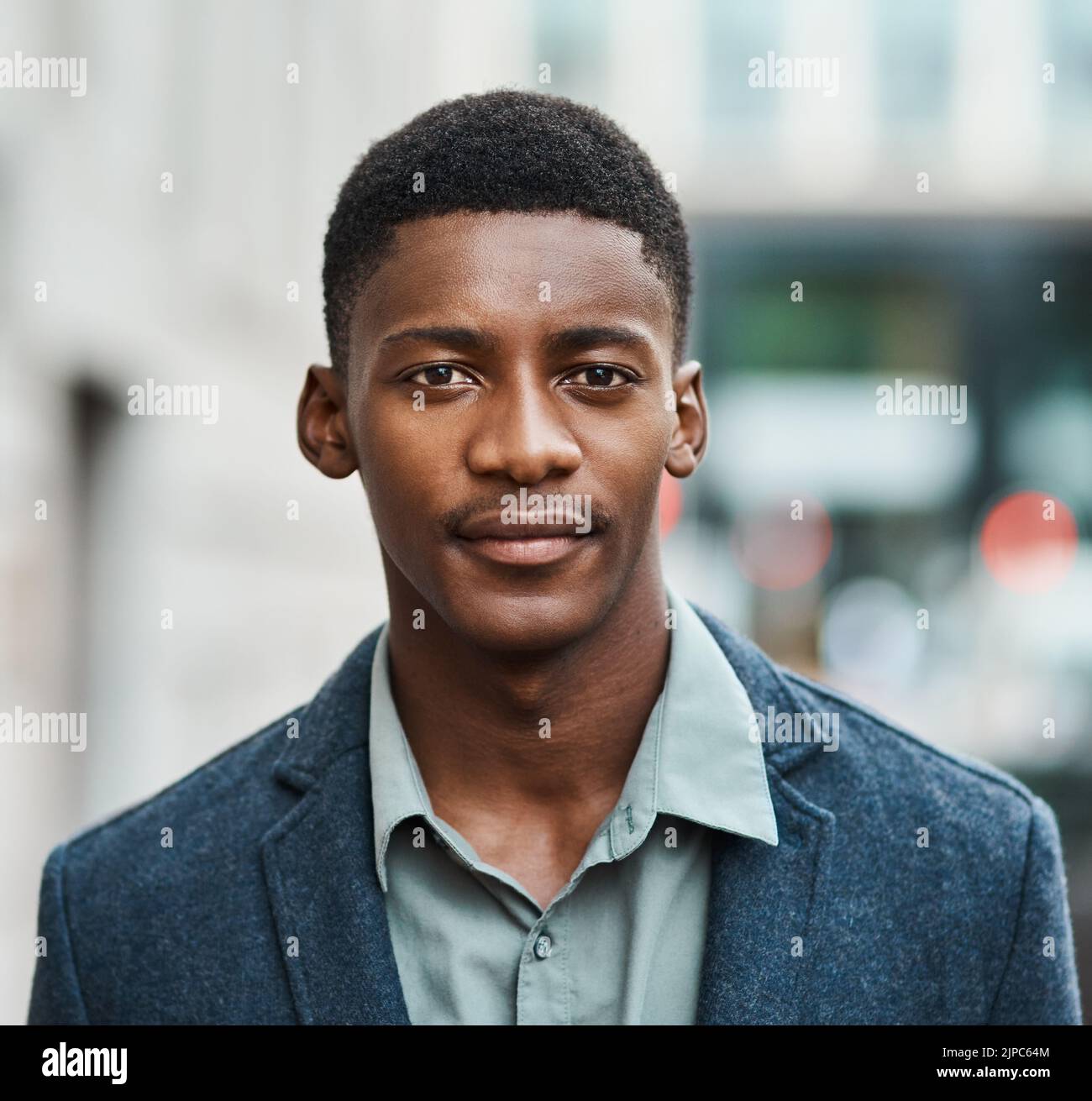 Portrait of a serious business man standing with a vision for ...