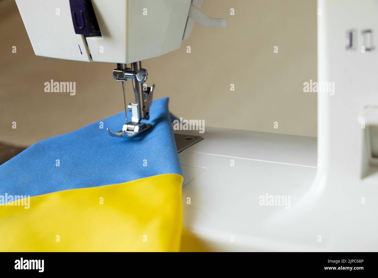 The flag of Ukraine on a home sewing machine, the production of ...