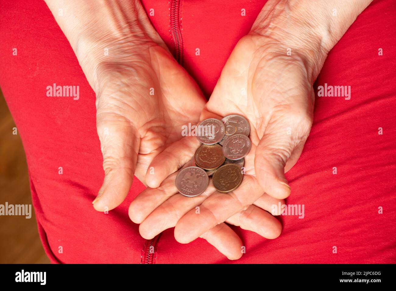 Women's hands hold ruble coins on their knees, default and poverty of ...