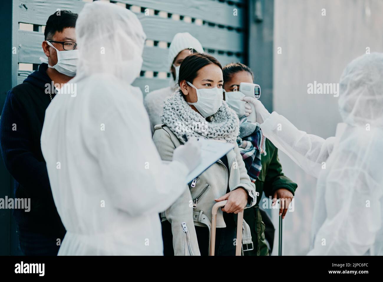 Travel healthcare worker testing covid temperature outside with an ...