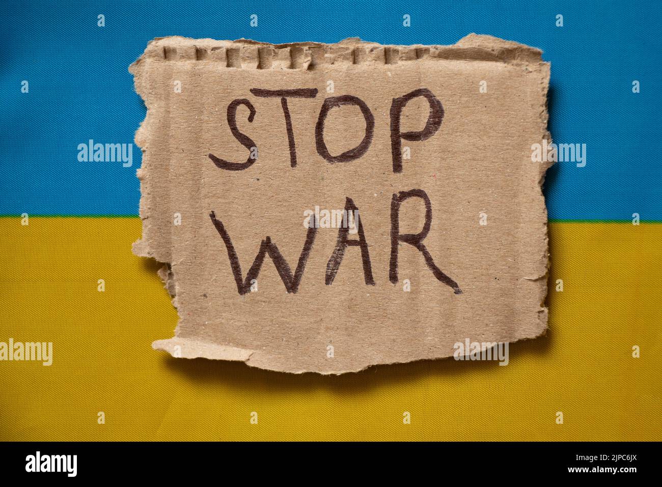 Cardboard plate with the inscription stop war against the background of ...