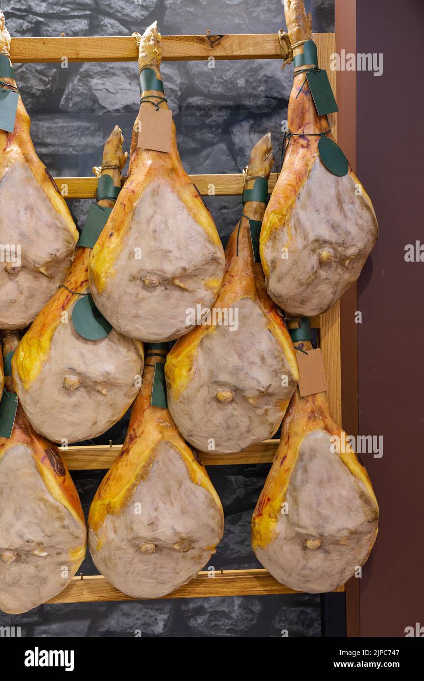 Group of Whole Raw Hams hung on a Wall Stock Photo - Alamy