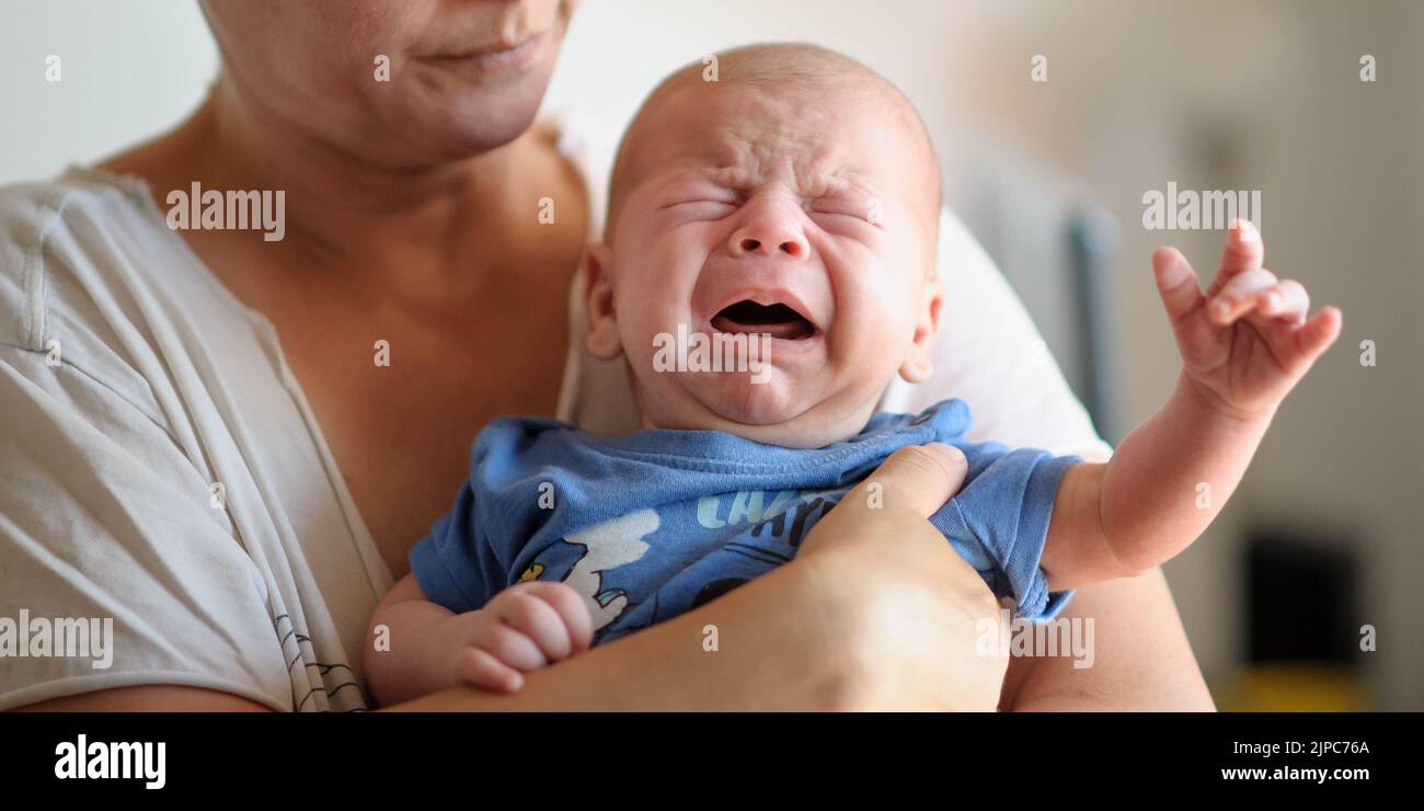 Sweet and cute small little newborn baby is hungry and upset and cry ...