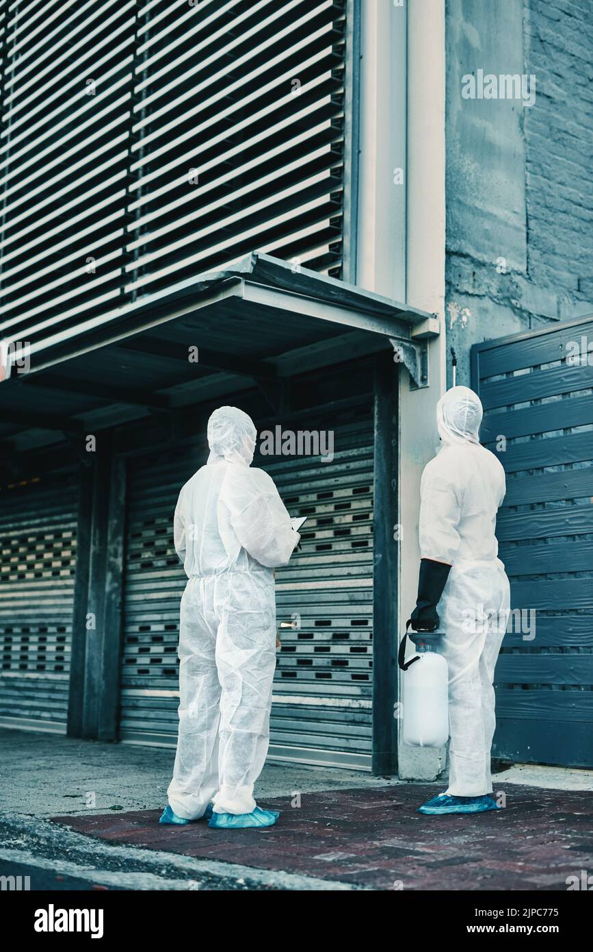 Medical team and covid hygiene healthcare workers wearing hazmat suits ...