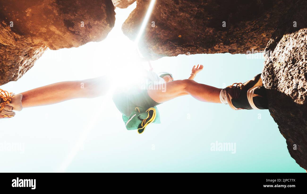 Low angle close up young caucasian sporty woman training steps on rock ...