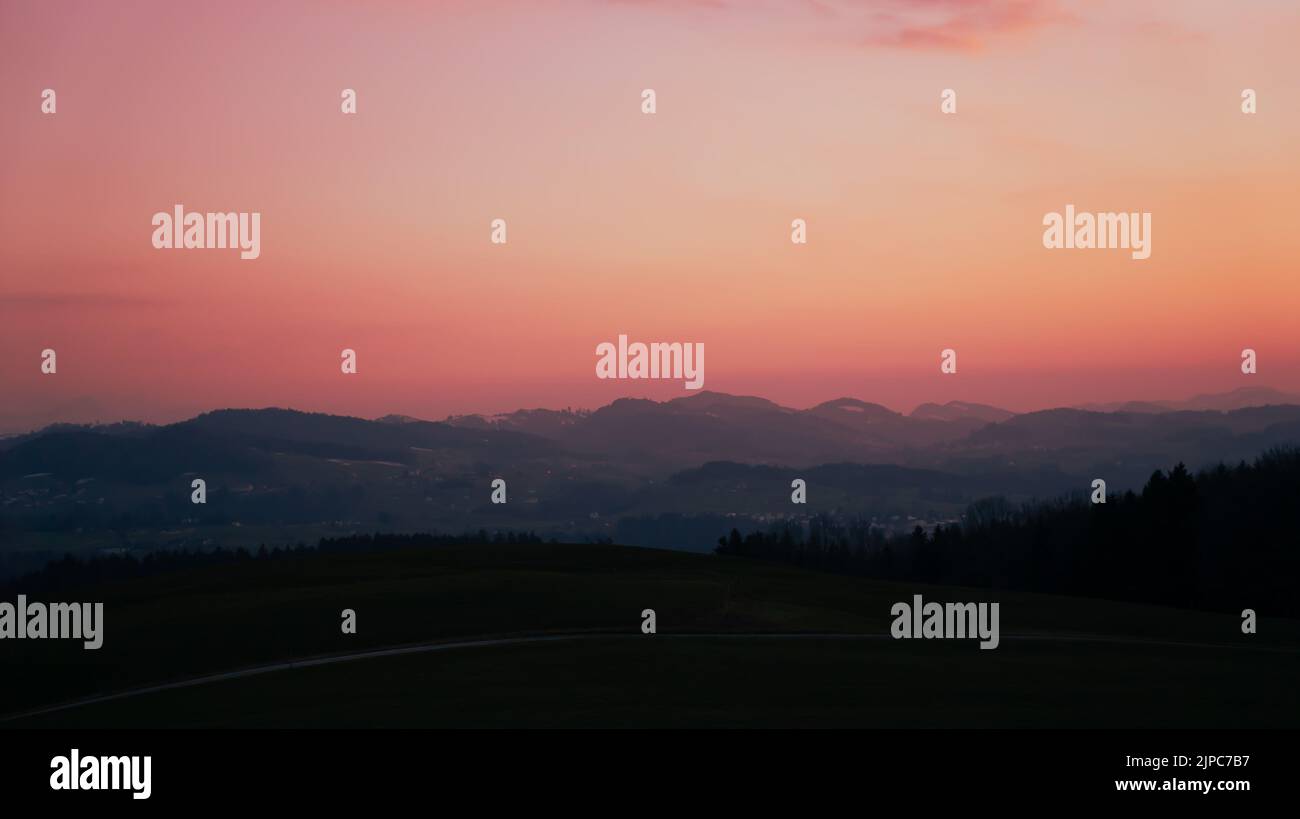 The pink shaded sunset sky over the mountains landscape Stock Photo - Alamy