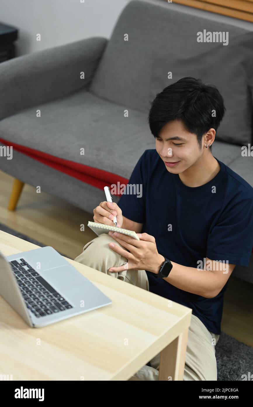 Handsome asian male freelancer working online with laptop and making ...