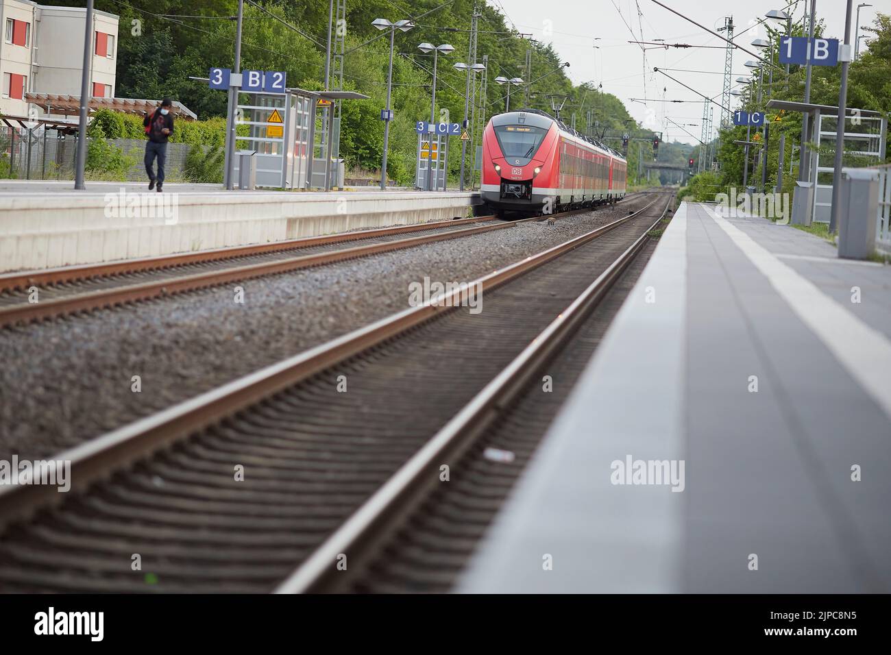 A red DB train arriving at a station in Geilenkirchen, Germany Stock ...