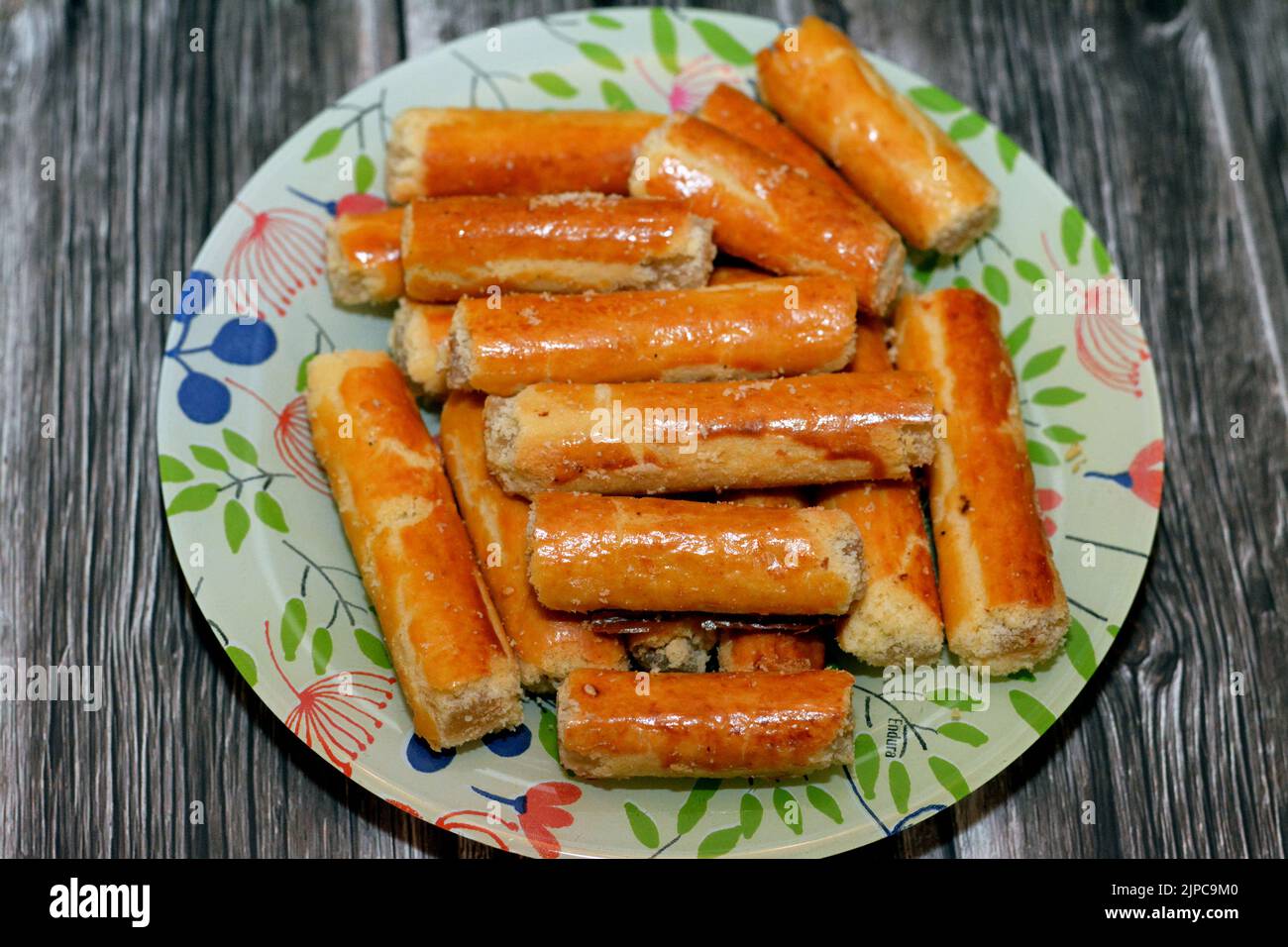 A plate of Arabian pastry of finger shaped cookies stuffed and filled ...