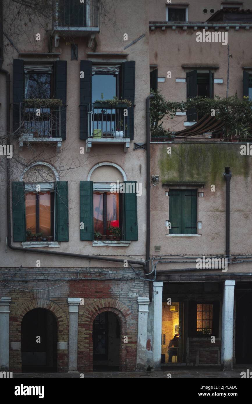 A vertical shot of a building with beautiful windows and balconies ...