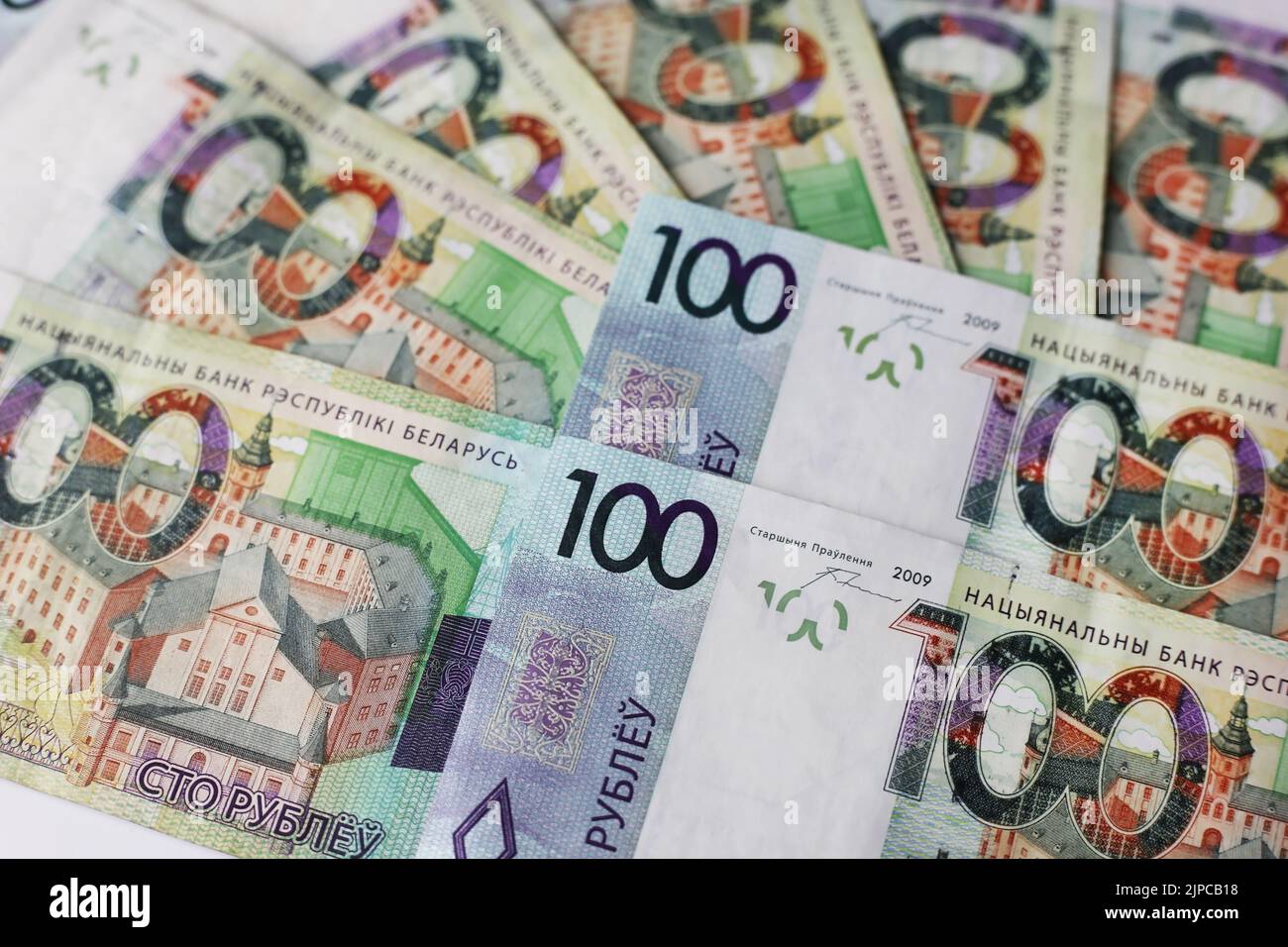 Banknotes of 100 belarusian rubles laid out on an isolated background ...