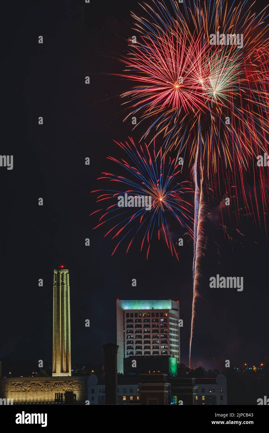 A vertical shot of exploding fireworks over Liberty Memorial in Kansas ...