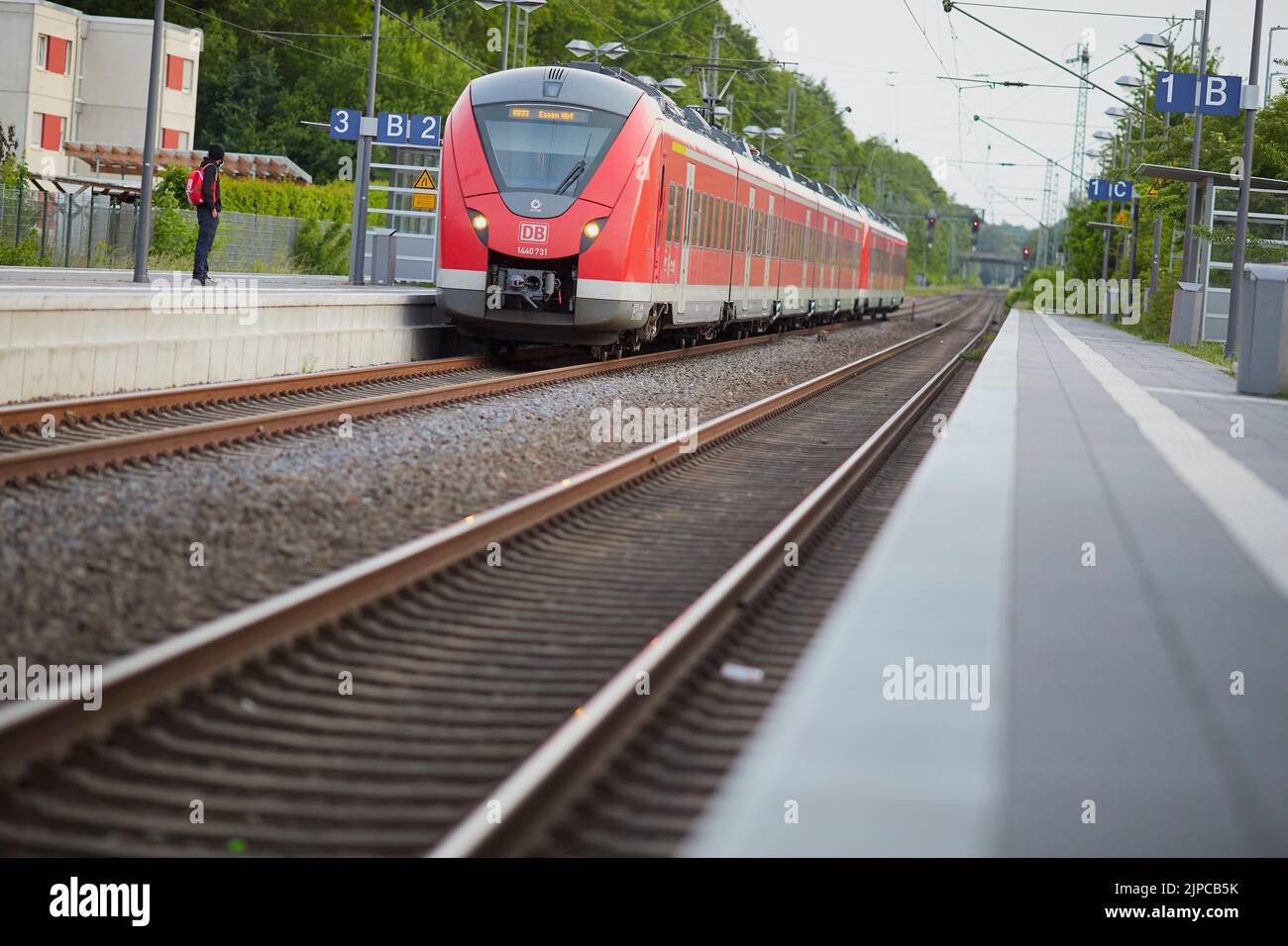 A red DB train arriving at a station in Geilenkirchen, Germany Stock ...
