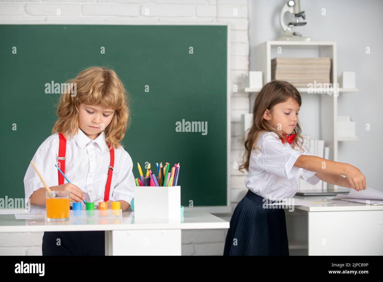 Cute school friends kids drawing and painting at school. Friendly boy ...