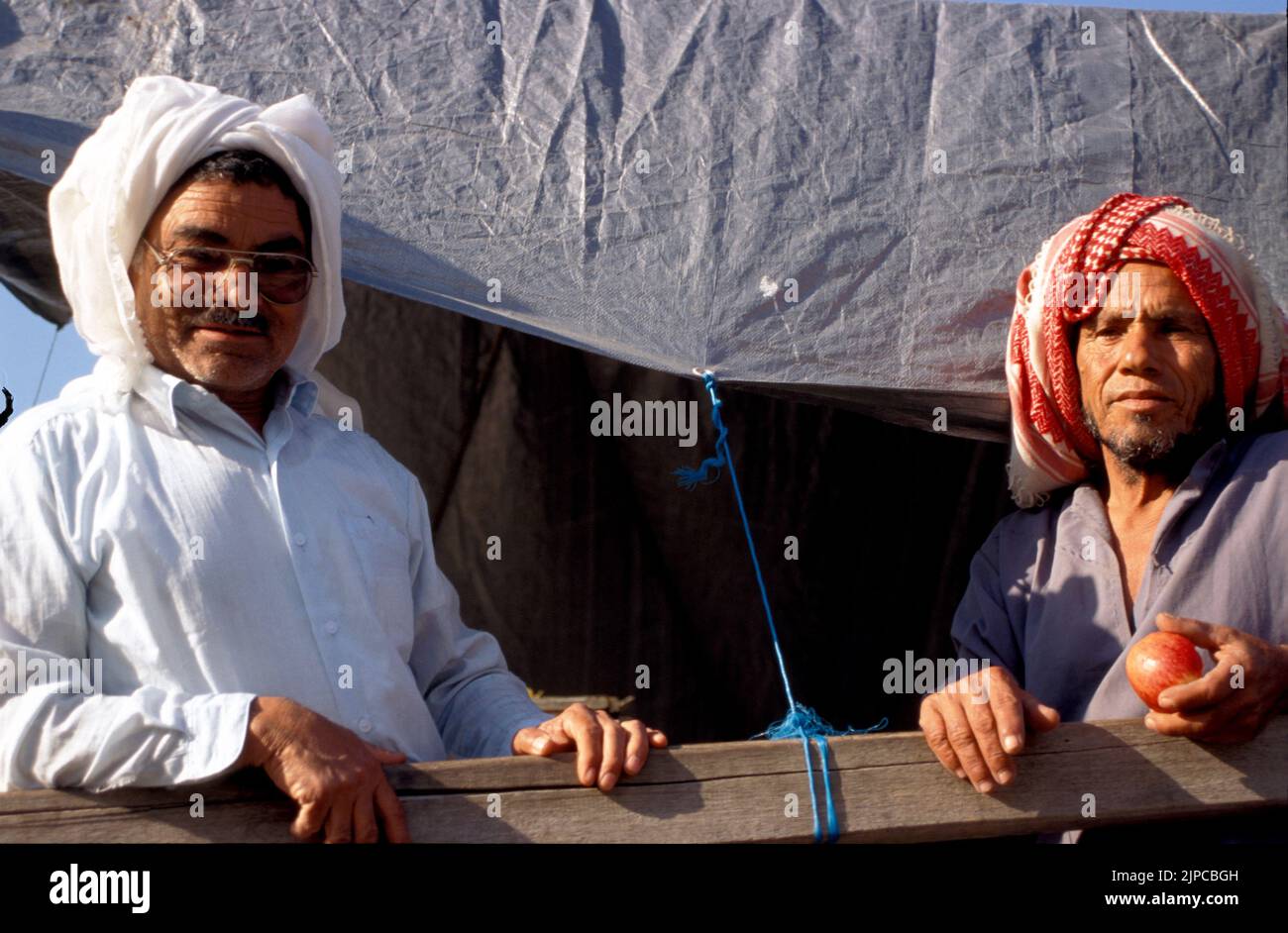 Crewmen aboard a traditional trading dhow moored in the Creek, Dubai ...