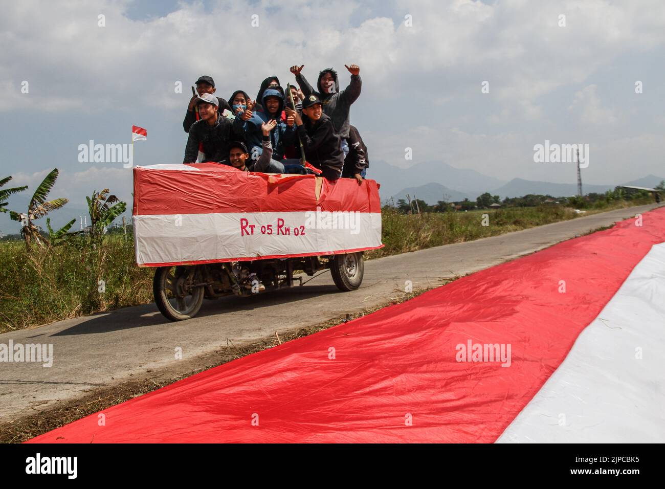 Rancaekek, West Java, Indonesia. 17th Aug, 2022. People ride past 77 ...