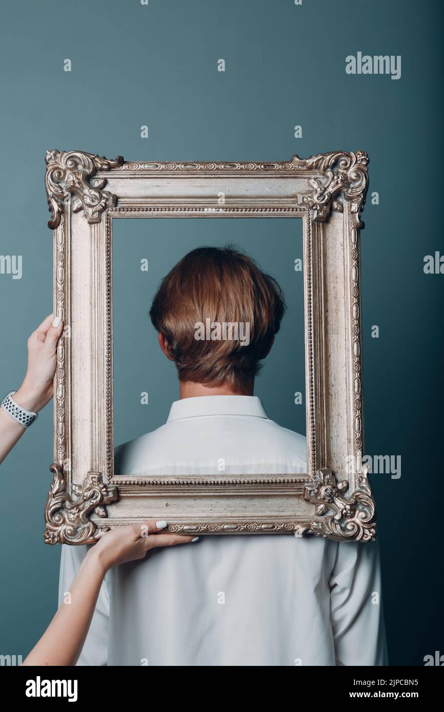 Millenial young man back rear head view with blonde hair on gilded ...