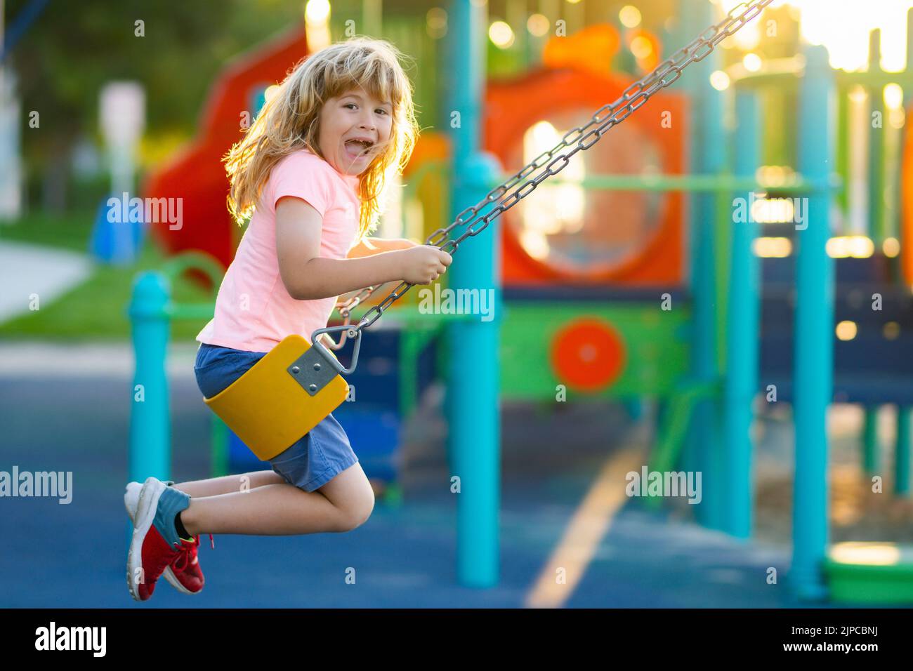 Child playing on outdoor playground. Kids play on kindergarten yard ...