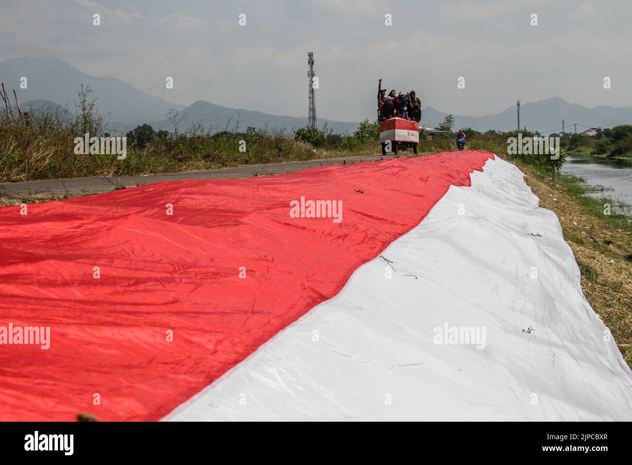 Rancaekek, West Java, Indonesia. 17th Aug, 2022. People ride past 77 ...