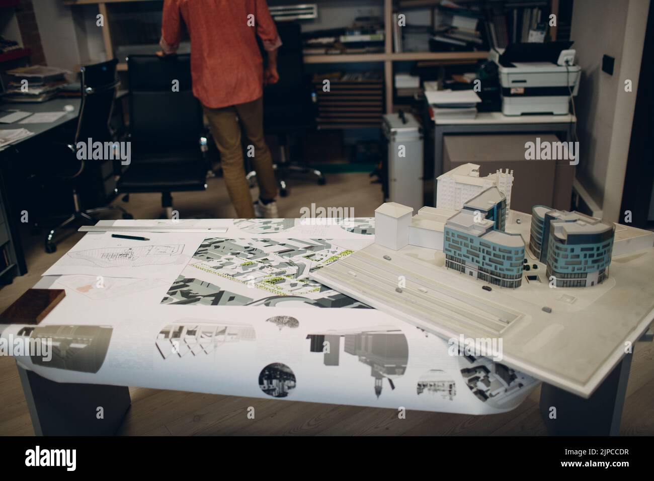 Architect with blueprints and layout design project at office bureau ...