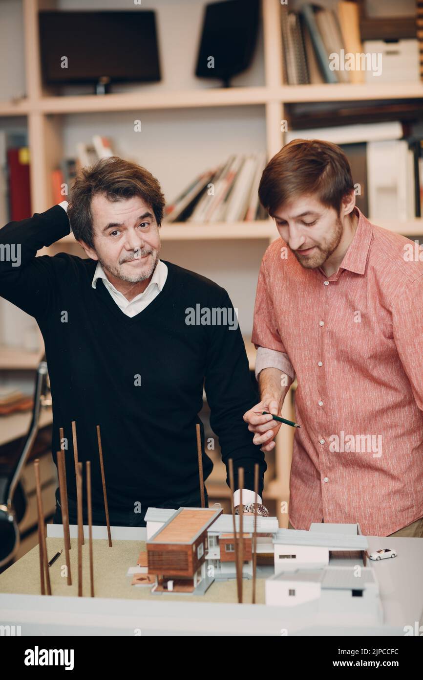 Architect with blueprints and layout design project at office bureau ...