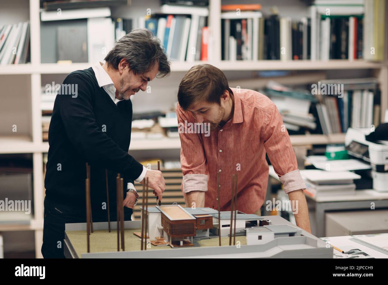 Architect with blueprints and layout design project at office bureau ...