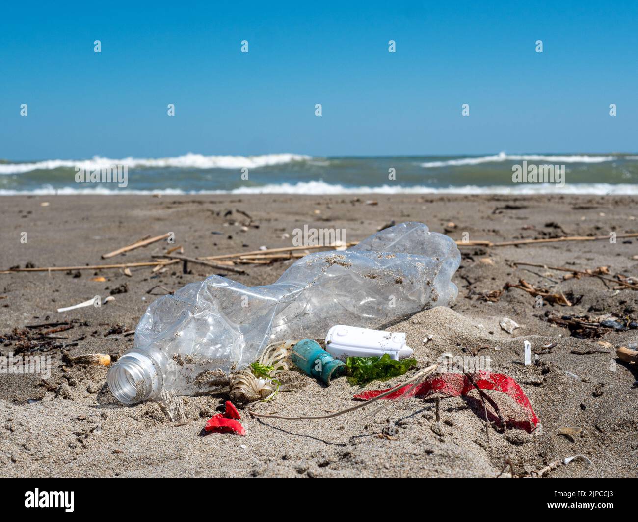 Plastic waste lies in the sand on the beach Stock Photo - Alamy