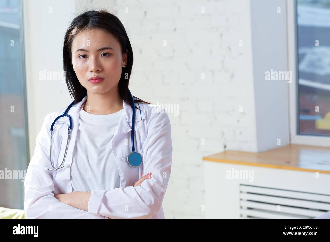 Asian positive doctor woman in white medical gown with stethoscope ...