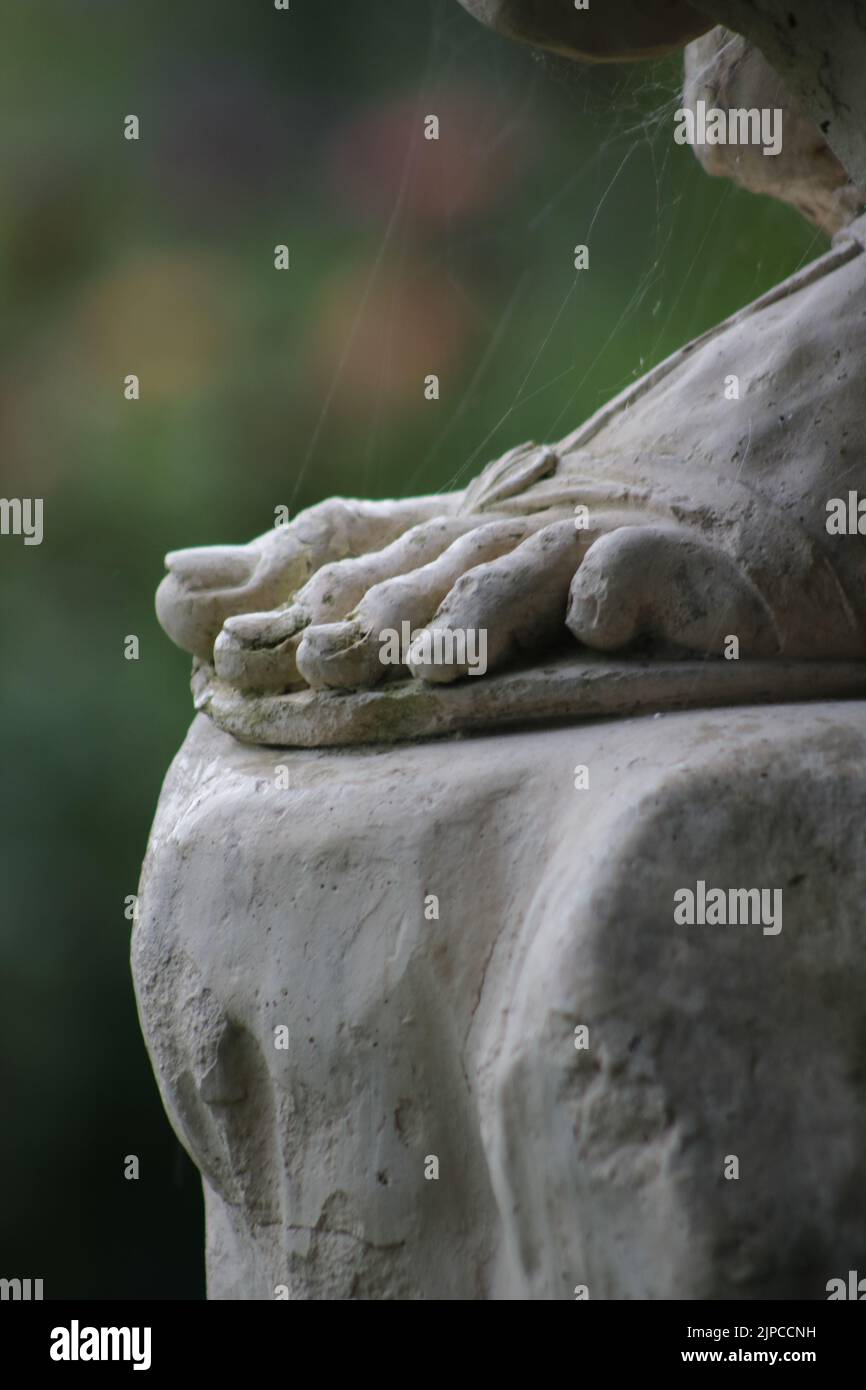 A white statue foot in spiderweb Stock Photo - Alamy