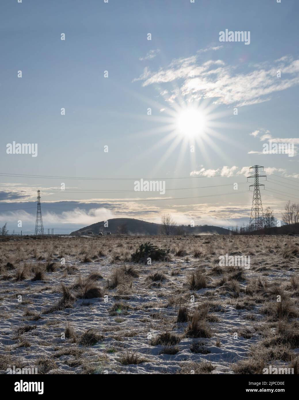 High voltage transmission towers and powerlines on snow-covered ground, Twizel, South Island ...